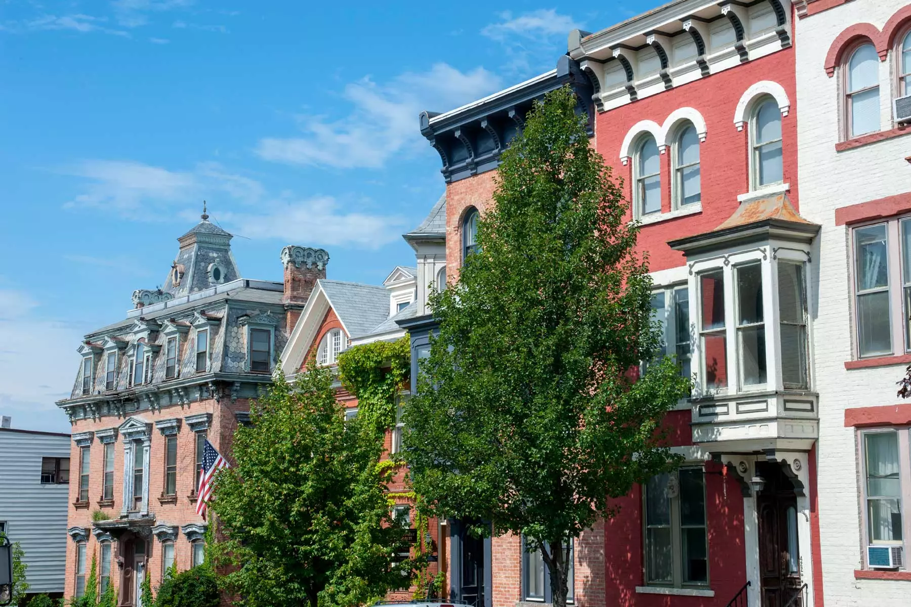 Bakstienhuzen en in Amerikaanske flagge op Warren Street yn 'e stêd Hudson oan' e Hudsonrivier yn 'e steat New York