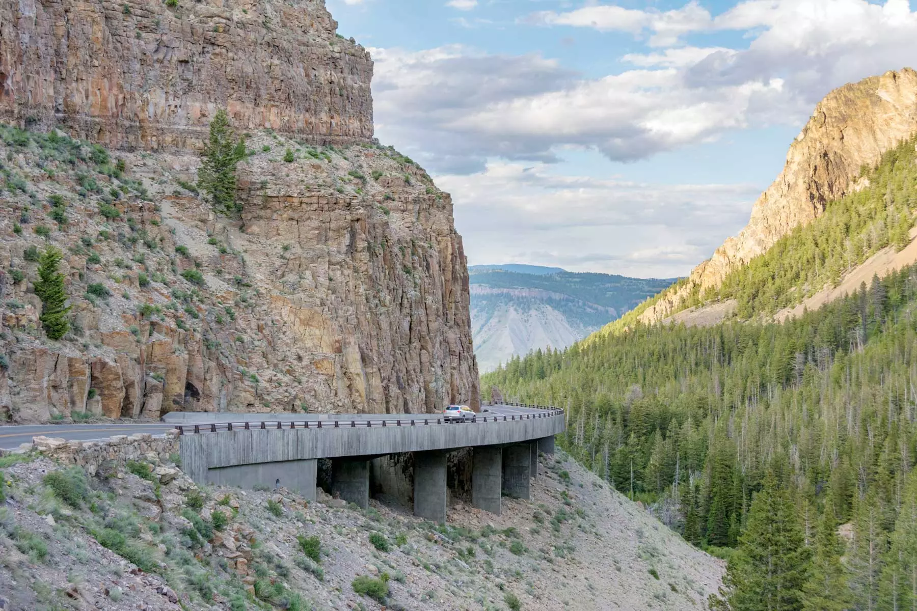 En bil kører langs en rute i Yellowstone National Park ved Golden Gate Canyon