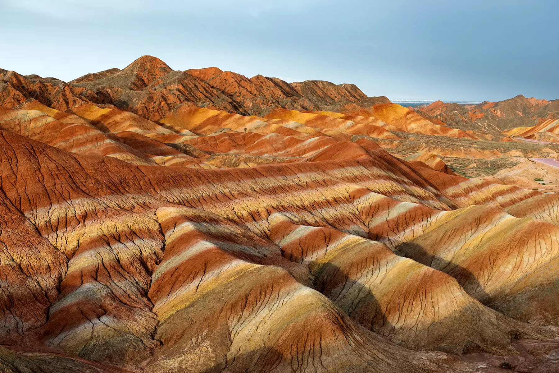 Zhangye Danxia National Geopark, Gansu, China. Indawo enemibala yezintaba zothingo. Izindlela zokuhamba ezizungeze ukwakhiwa kwamatshe e-sandstone e-Zhangye National Geological Park.