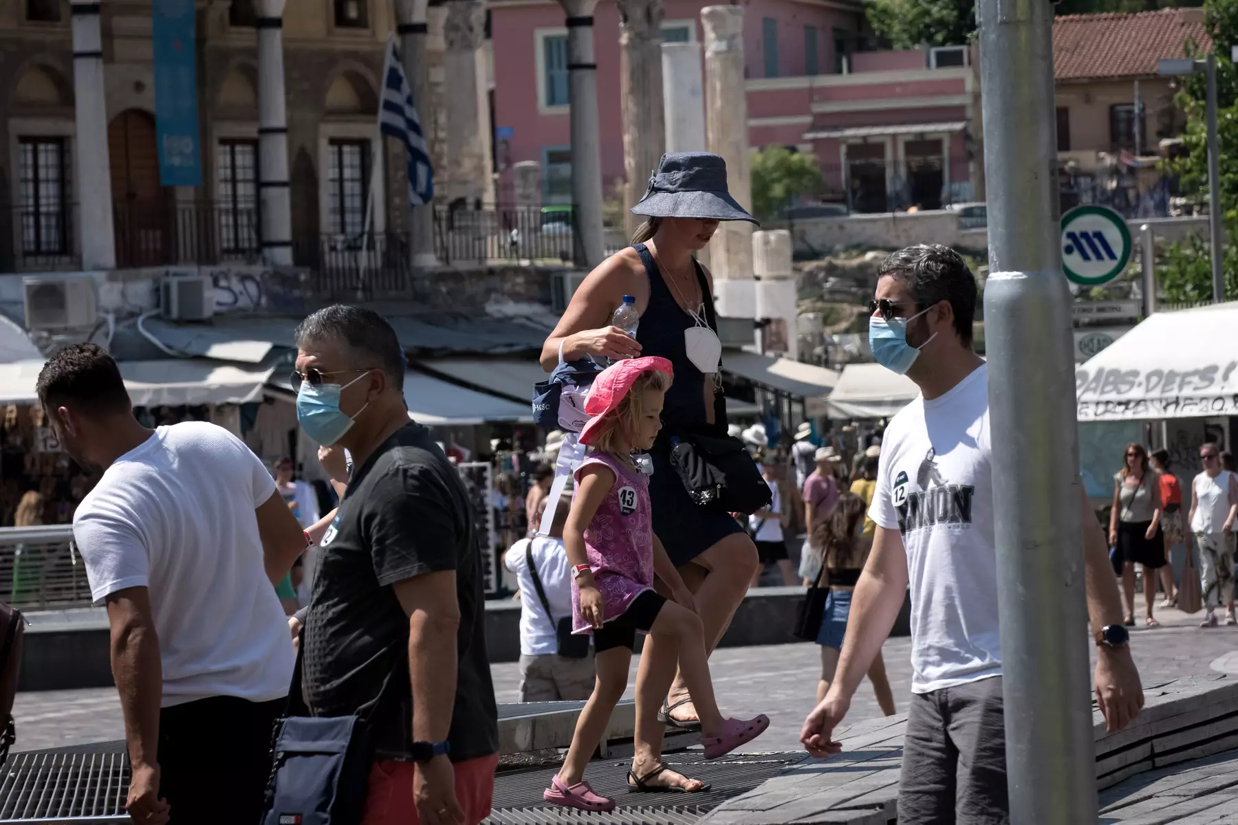 Turistoj viditaj ĉe Monastiraki placo en Ateno, Grekio la 14-an de julio 2021.