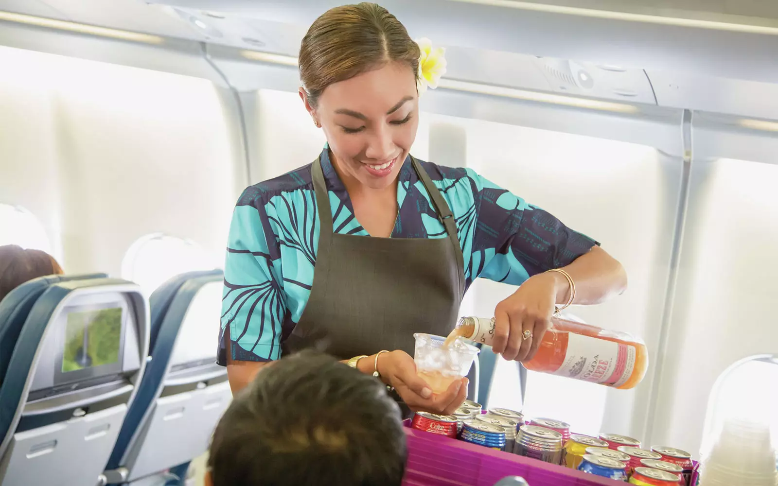 Genietsje fan fergese drankjes lykas de Koloa Breeze Rum Punch by it fleanen mei Hawaiian Airlines.