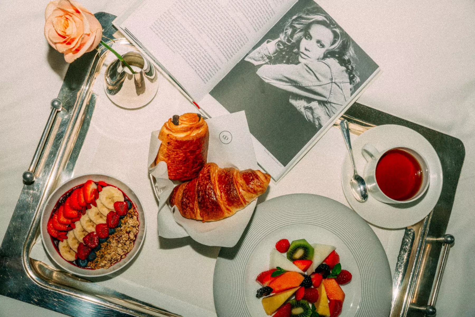 Acima vista da bandeja de café da manhã com frutas e croissants e chá