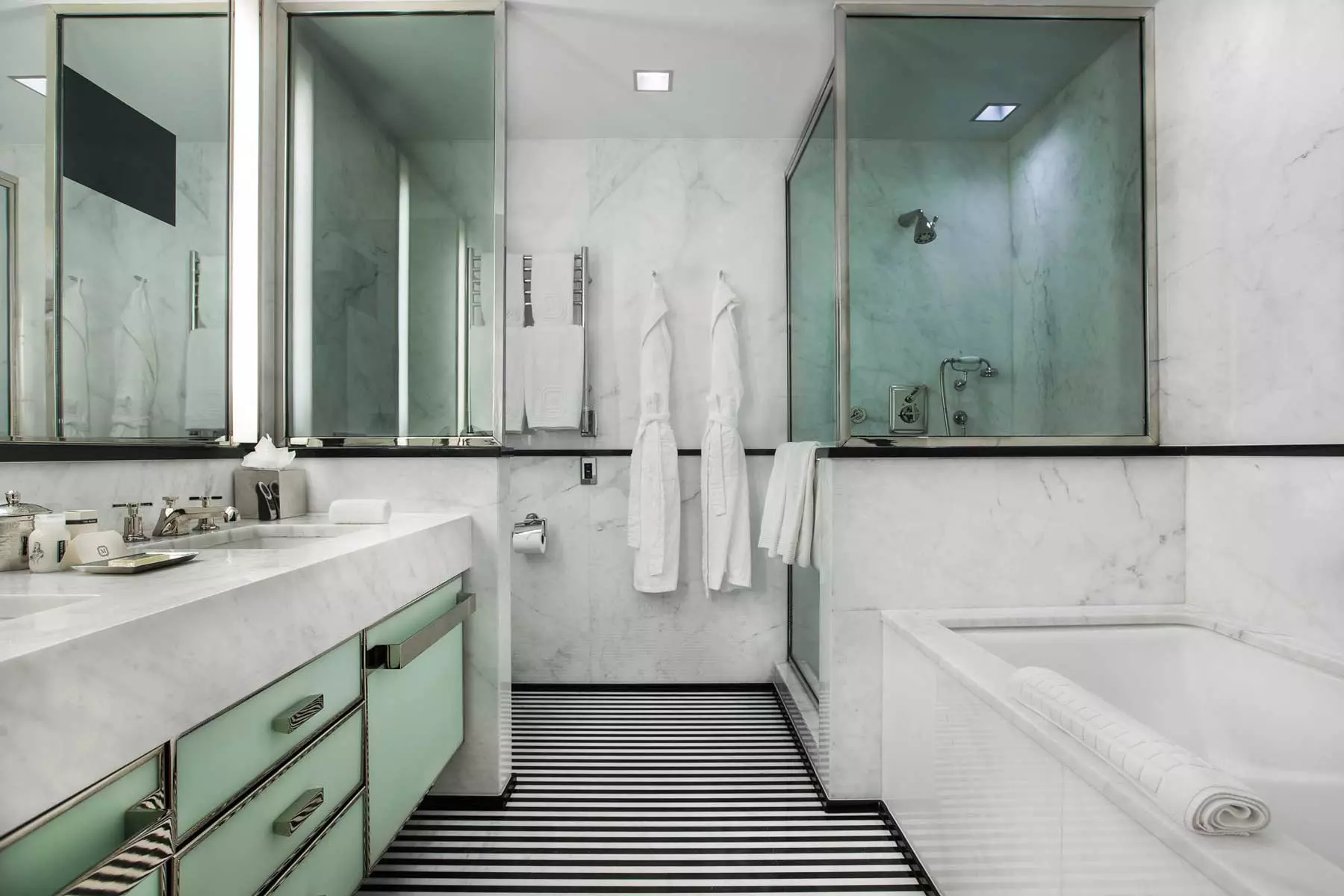 Un baño de color negro, blanco y menta en The Mark, votado como uno de los mejores hoteles de la ciudad de Nueva York