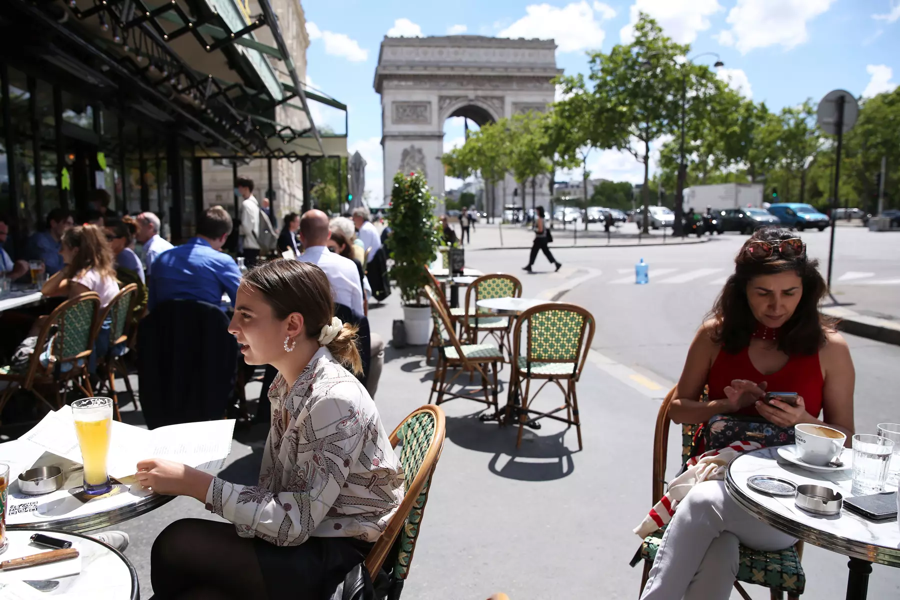 Dadku waxay ku qadeeyaan makhaayad u dhow Arc de Triomphe ee Paris, Faransiiska, Juun 18, 2020