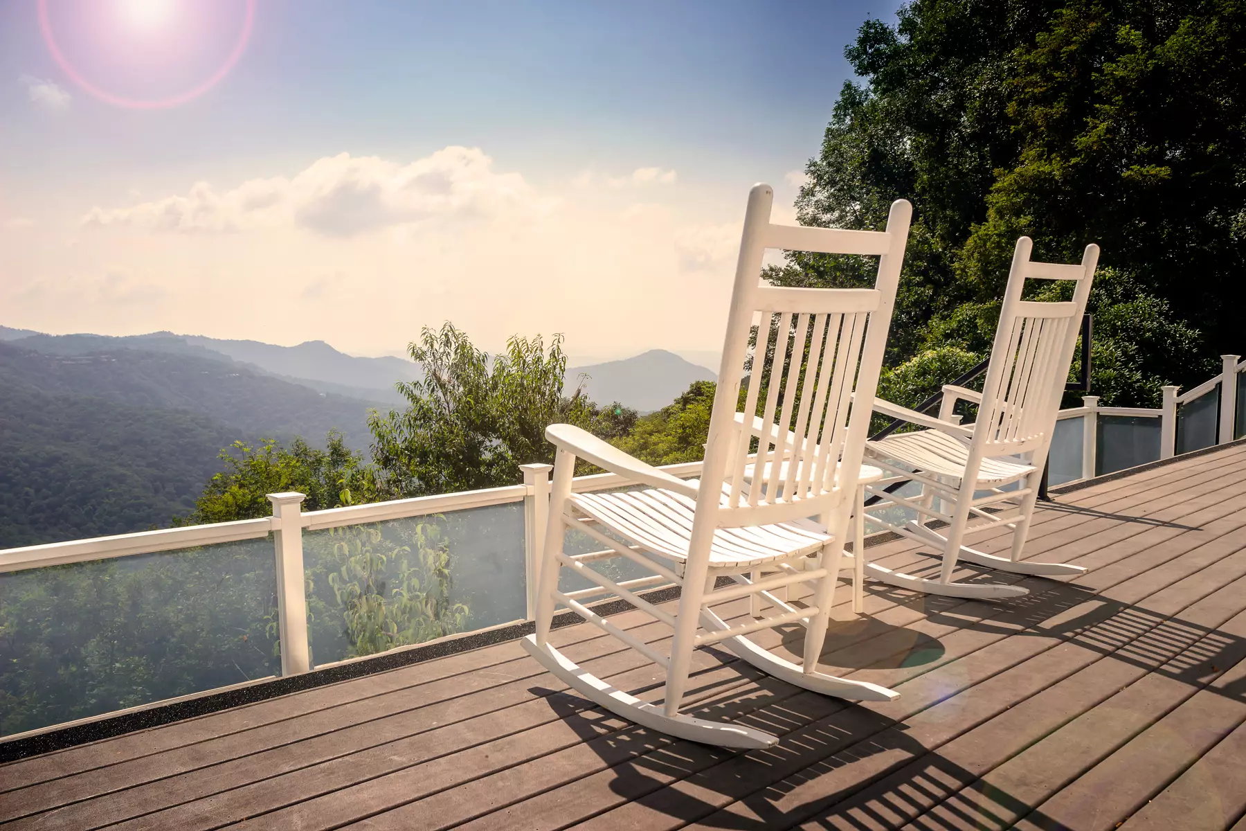 Schaukelstühle auf einer Terrasse mit Blick auf die Bergkette