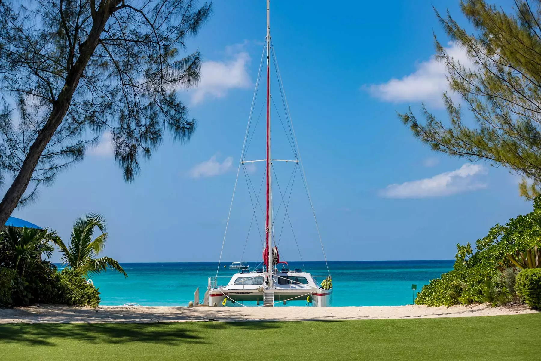 Catamaran Moored yn Ynysoedd Cayman, Tiriogaeth Prydain, ym Môr y Caribî.