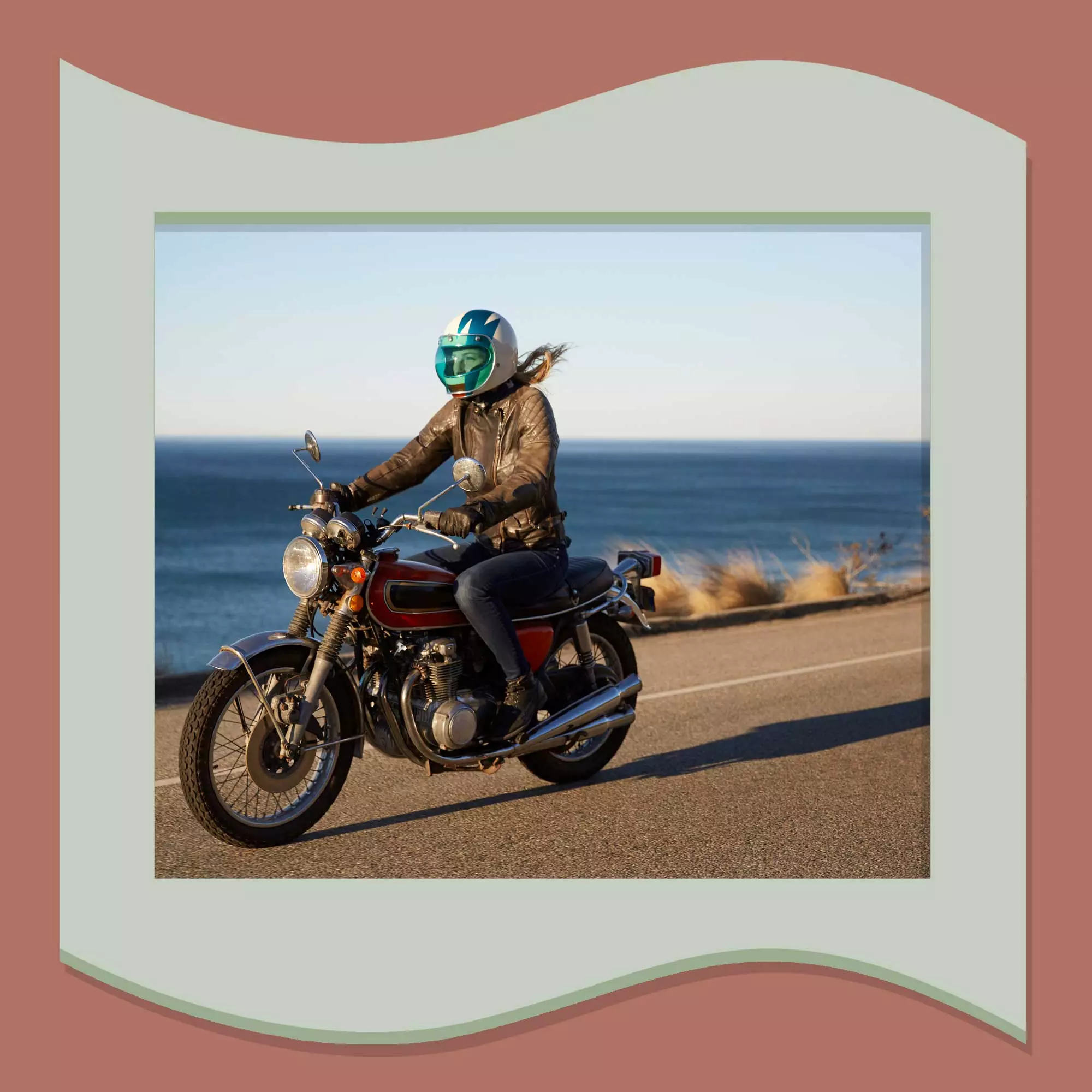 La donna guida la moto lungo la strada panoramica sull'oceano