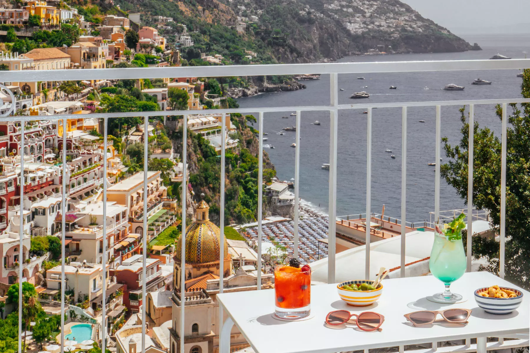 Sonbril op 'n terrastafel by Hotel Poseidon wat uitkyk oor Positano